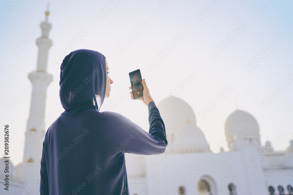 Traveling by Unated Arabic Emirates. Pretty young woman in traditional ...