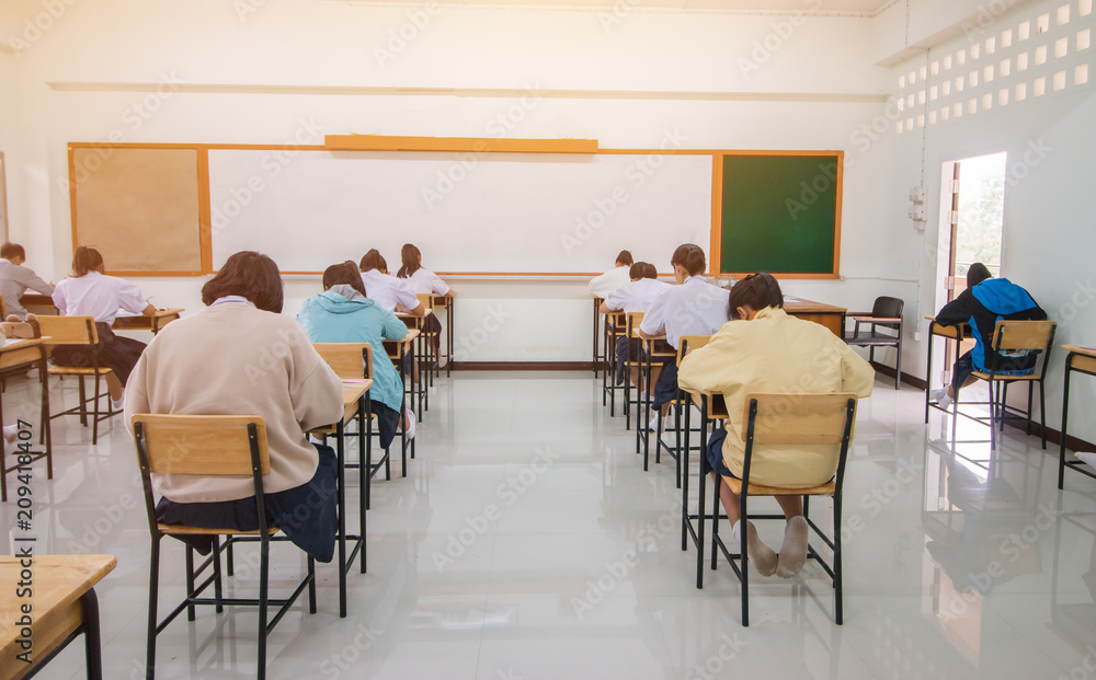 Behind Asian School students in uniform taking examination and writing ...