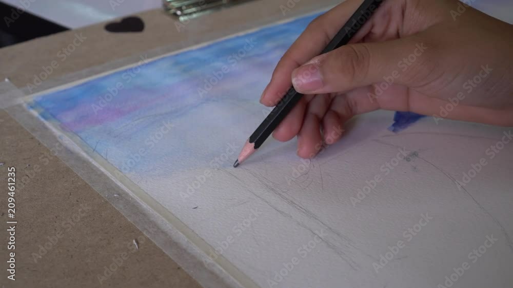 Student's hand with brush drawing on paper for creation picture ...