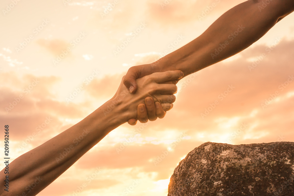 Hand helping hand up a mountain. Stock Photo | Adobe Stock