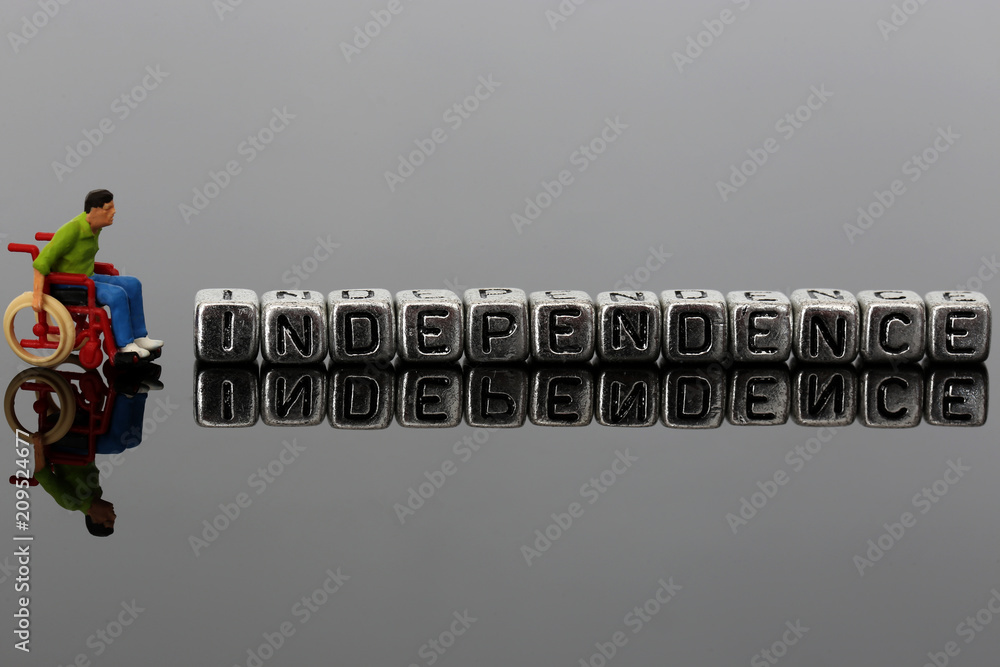 Miniature scale model man in a wheelchair with the word independance on ...