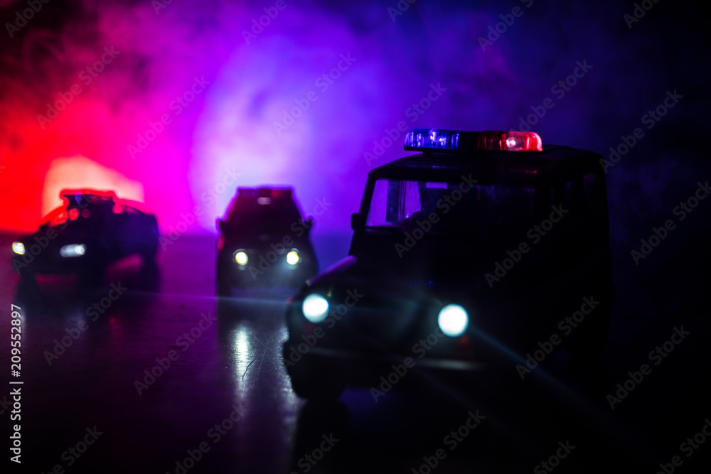 Police car chasing a car at night with fog background. 911 Emergency ...