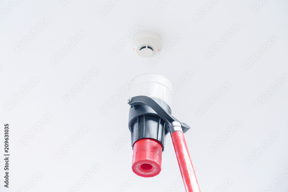 Automatic smoke detector fire alarm head on the ceiling. The smoke ...