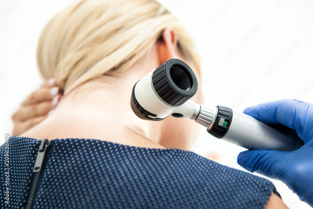 Examination of the patient's skin by a dermatologist using a ...