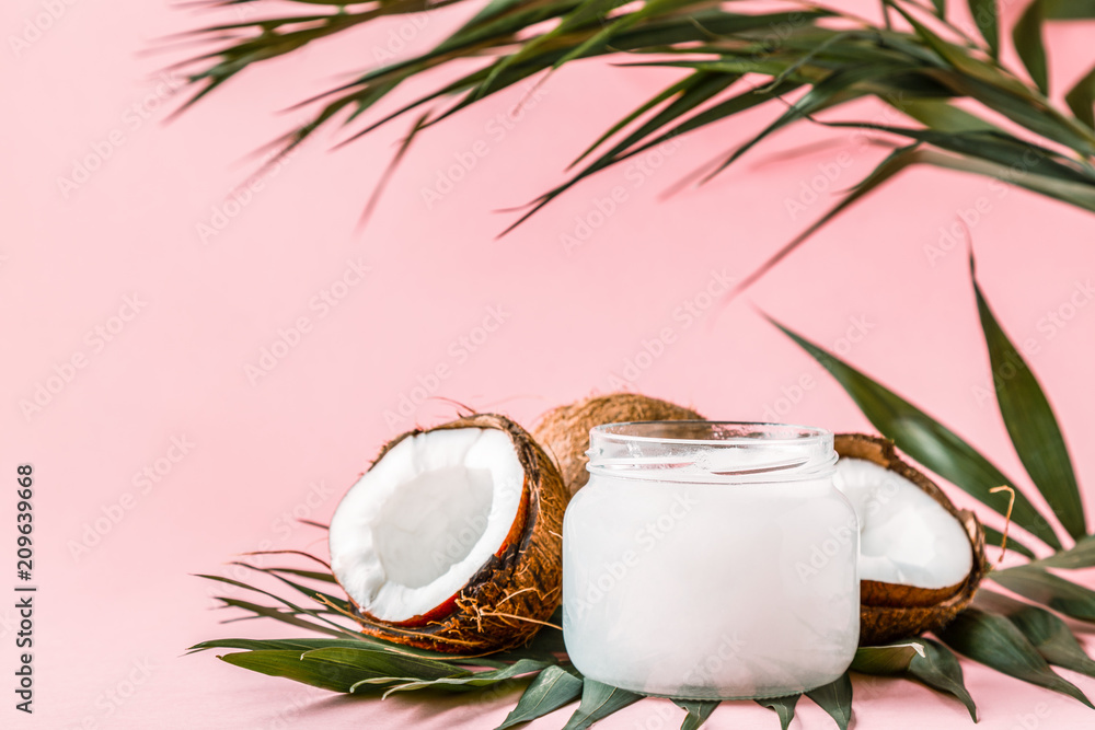Coconut oil and coconuts on a bright pastel background. Stock Photo ...