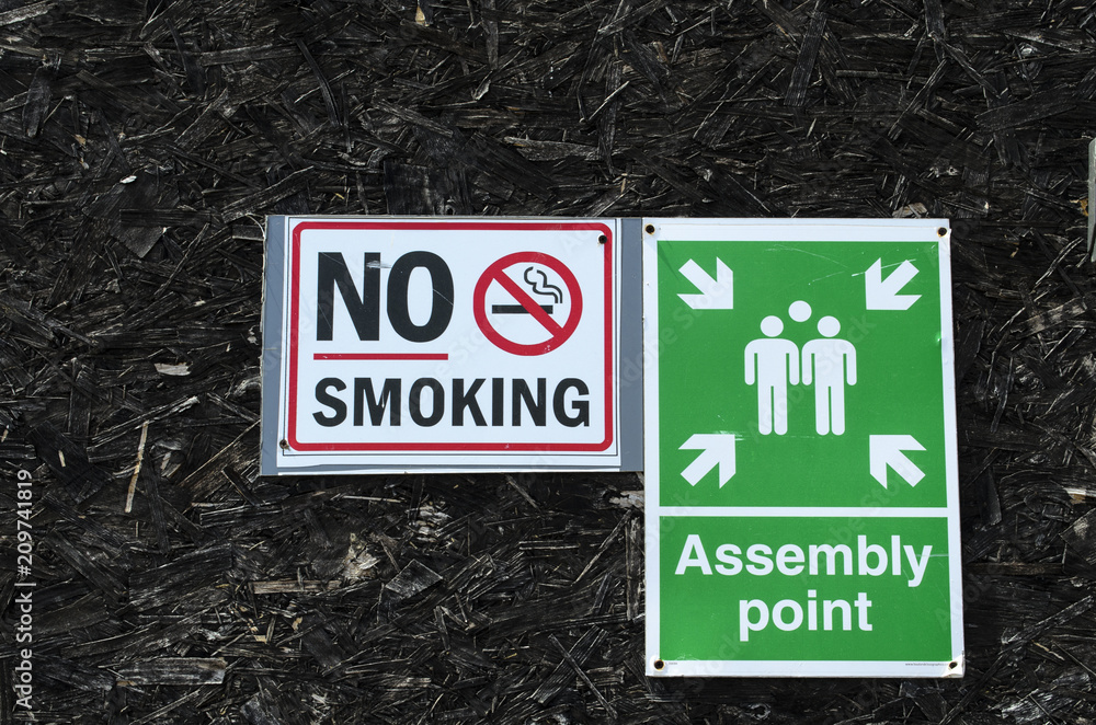 No smoking plus assembly point sign UK Stock Photo | Adobe Stock