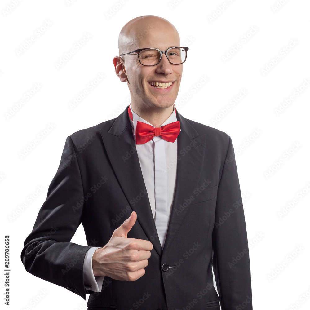 Slim bald elegant nerd with glasses and red bow tie looks at the camera ...