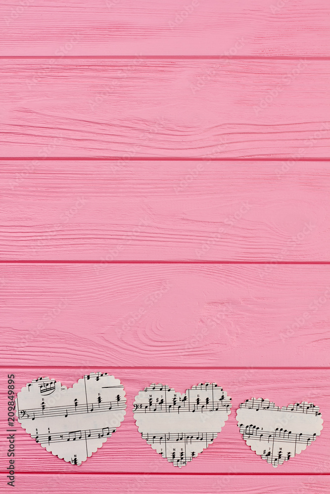 Three hearts with music notes. Row of paper heart shaped cutouts with ...