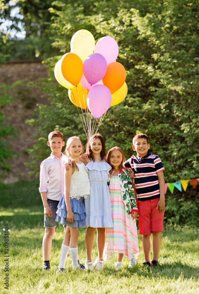 holidays, childhood and celebration concept - happy kids with balloons ...
