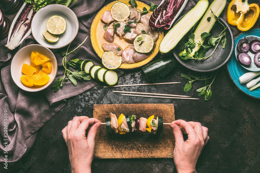 Female hands holding Chicken meat and vegetables skewer on cutting ...