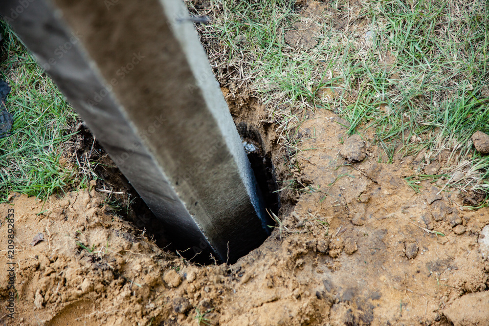 Group of foundation concrete pile put into the ground as structure base ...