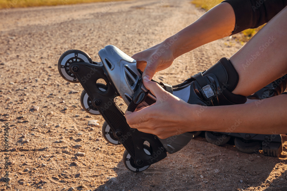 teenage girl rollerblading on the street on the road in the countryside ...