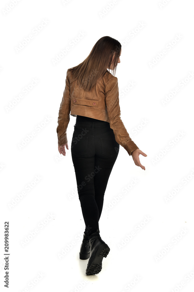 full length portrait of brunette girl wearing brown leather jacket ...