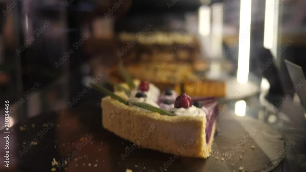 Catering food layout - various cakes are laid out in glass showcase ...