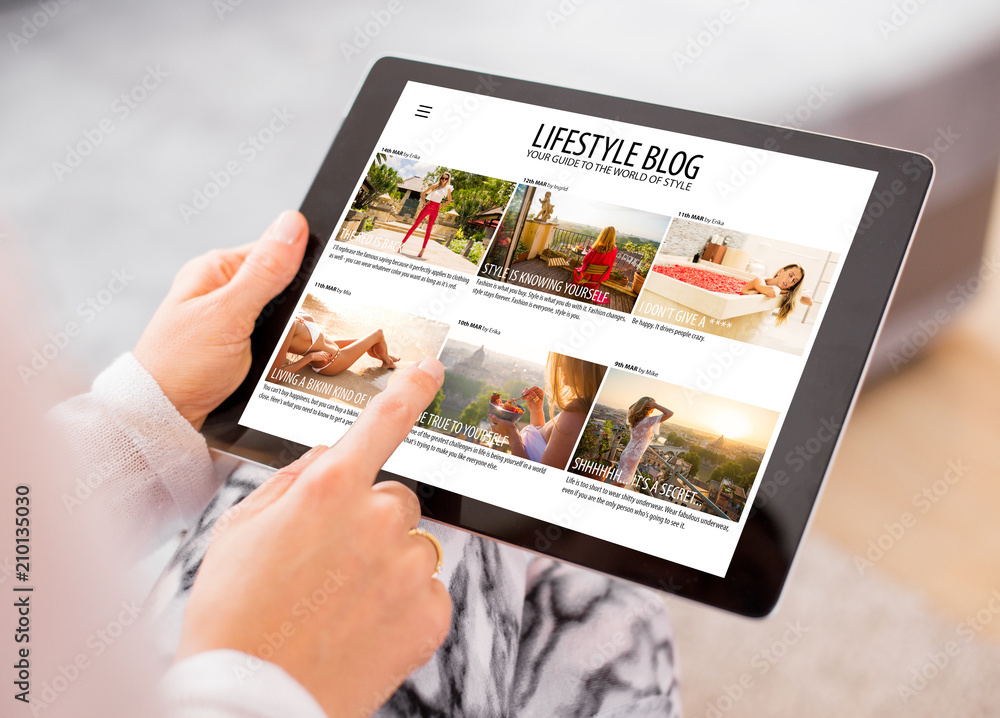 Woman reading blog on tablet. All contents are made up. Stock Photo ...