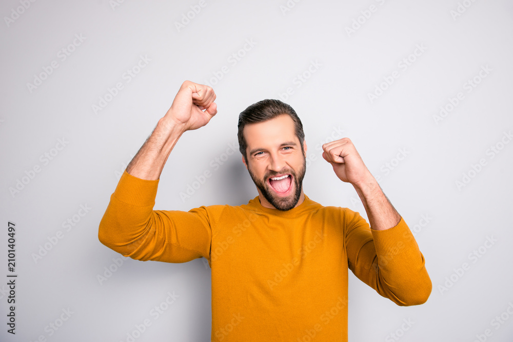 Portrait of cheerful joyful man keeping hands up celebrating ...