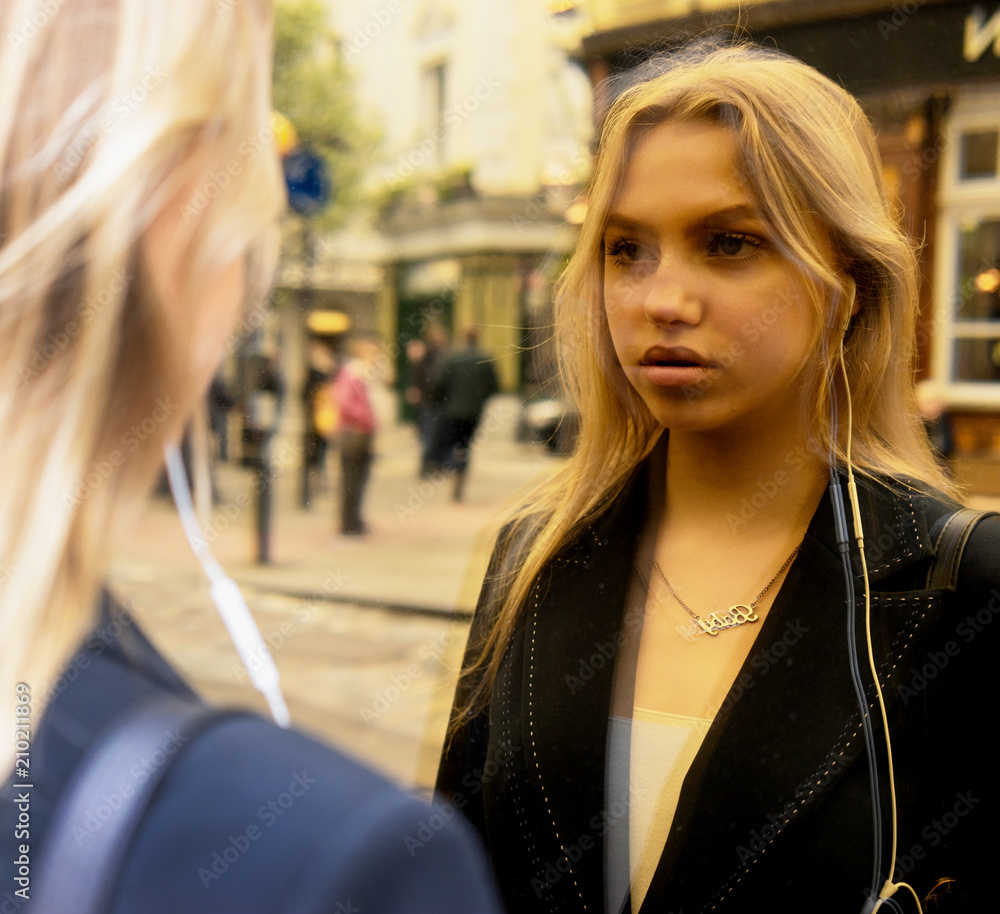 Reflection on a teenage girl in a window with head phones in Stock ...