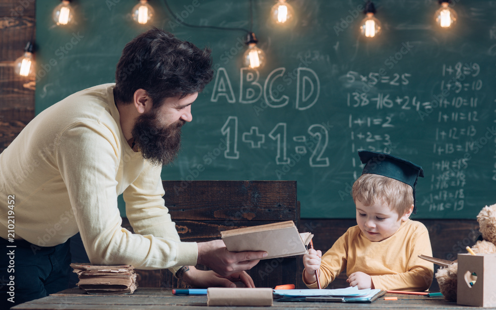 Wunderkind and genius concept. Father, teacher reading book, teaching ...