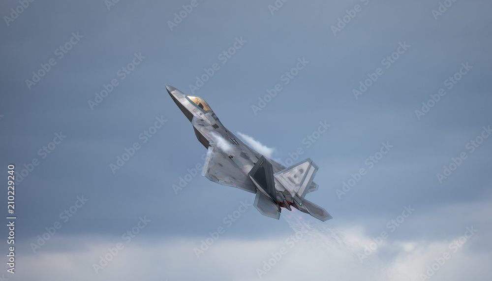 F-22 Raptor in a high G maneuver, with condensation trails forming ...