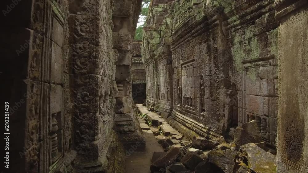 POV: Walking down narrow path between two beautiful decaying Buddhist ...
