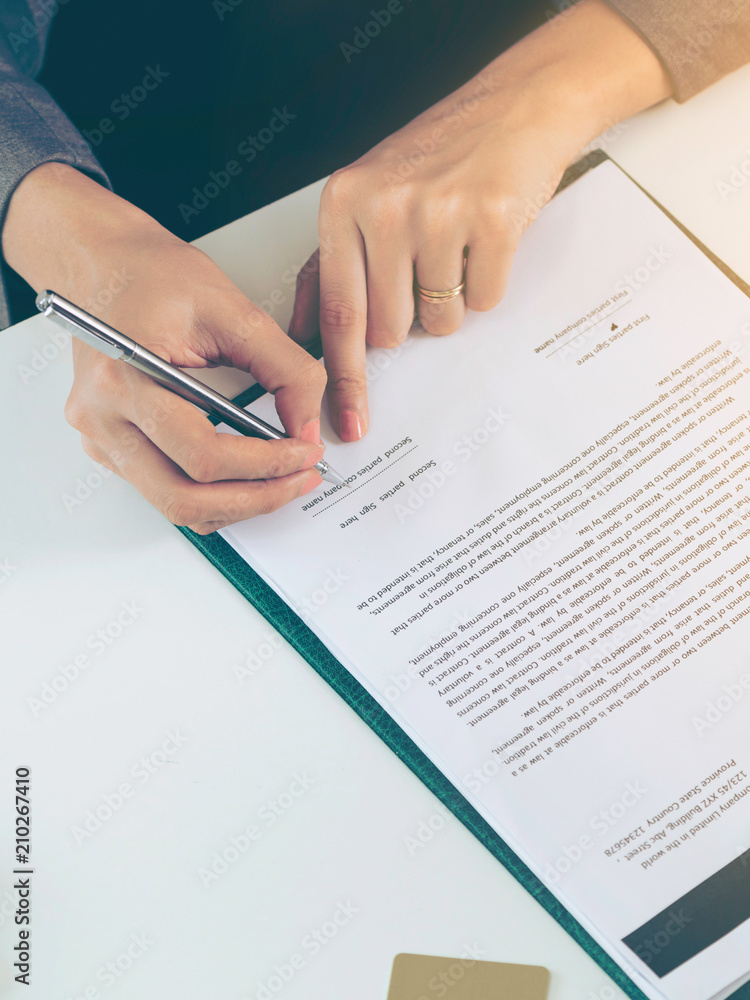 Businesswoman signs agreement contract in office. Stock Photo | Adobe Stock
