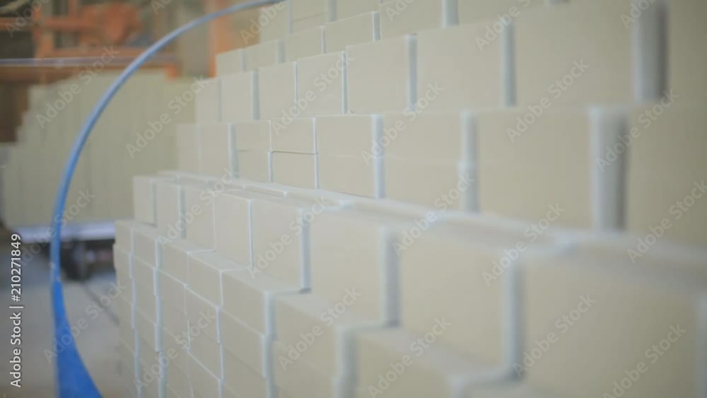 Production of white bricks. Brickworks. Wooden beams and boards neatly ...
