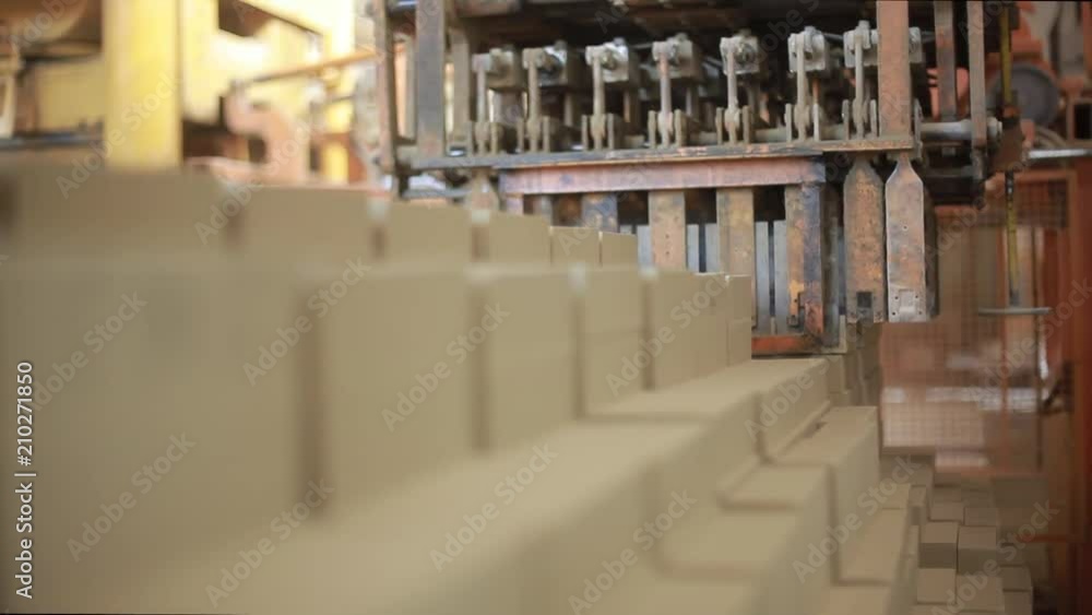 Production of white bricks. The robot truck loads the bricks ...