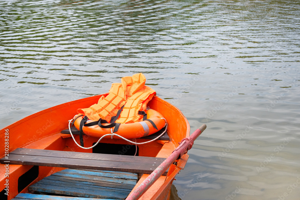 Boat, life jacket, lifebuoy in orange color important for life rescue ...
