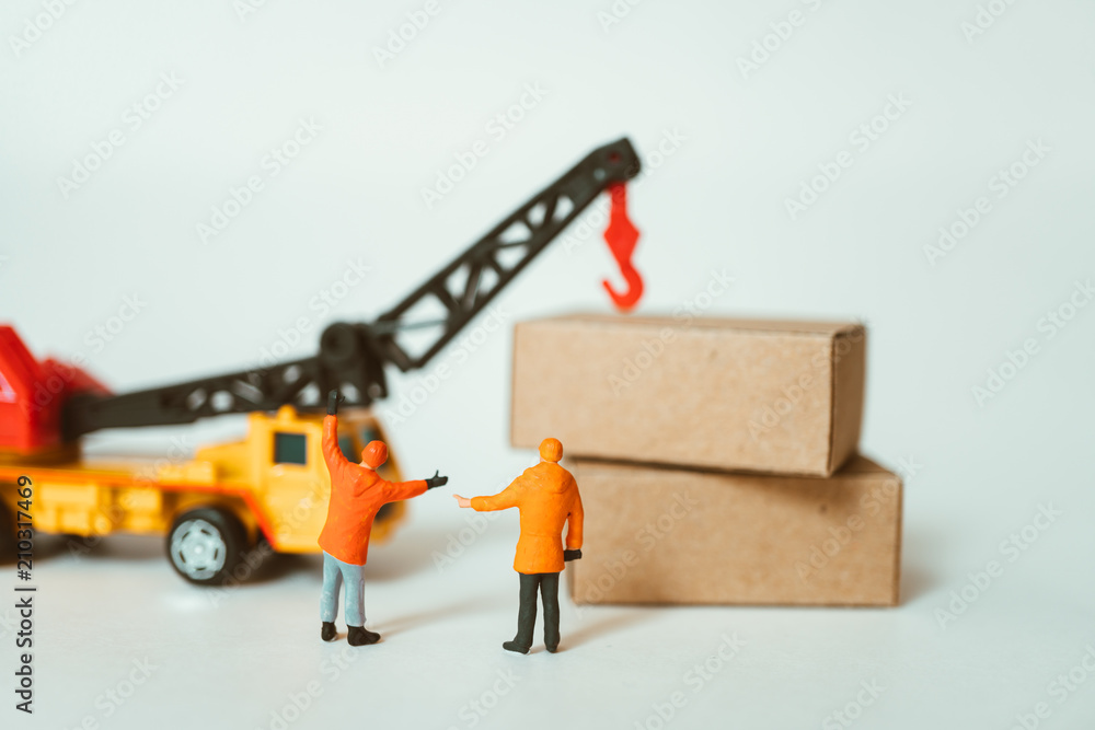 Miniature people, engineer working at construction site using as ...