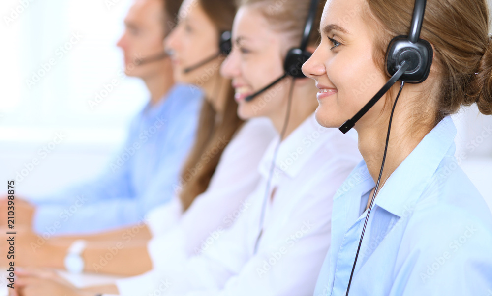 Call center operator in headset while consulting client. Telemarketing ...