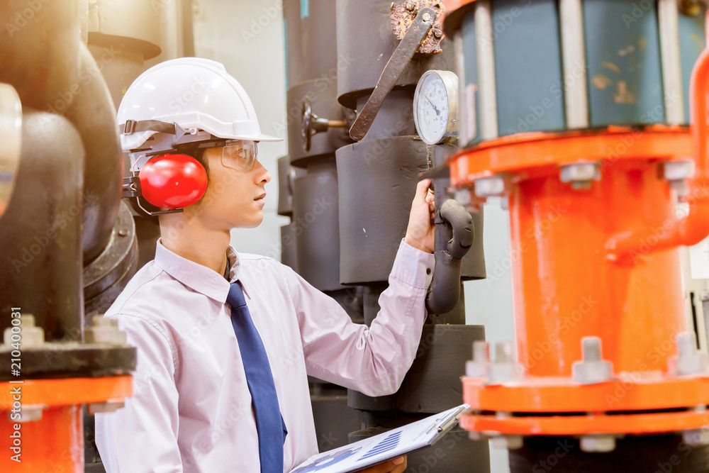 Engineer checking Condenser Water pump and pressure gauge , chiller ...