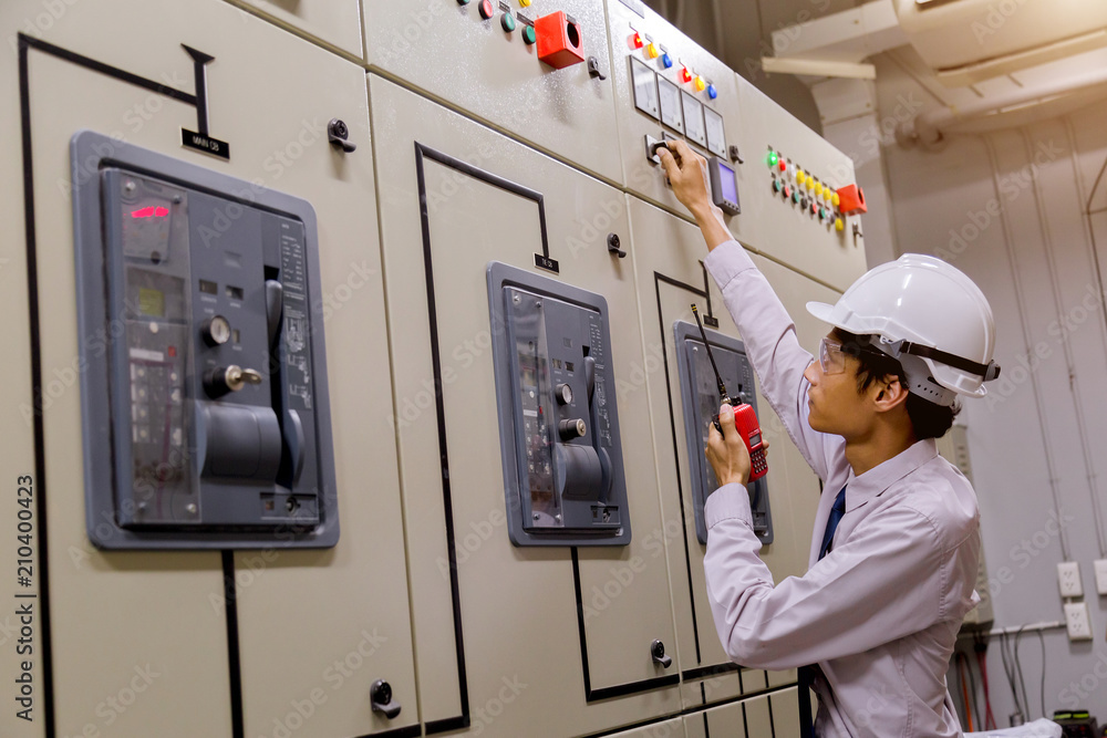Control Room Engineer. Power Plant Control Panel. Engineer standing in ...