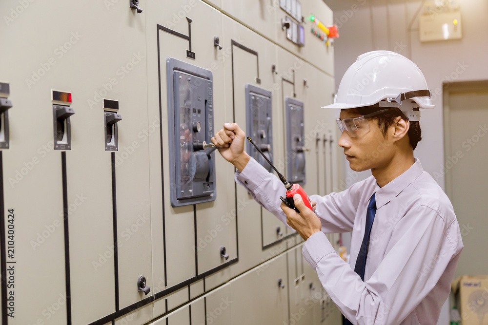 Control Room Engineer. Power Plant Control Panel. Engineer standing in ...