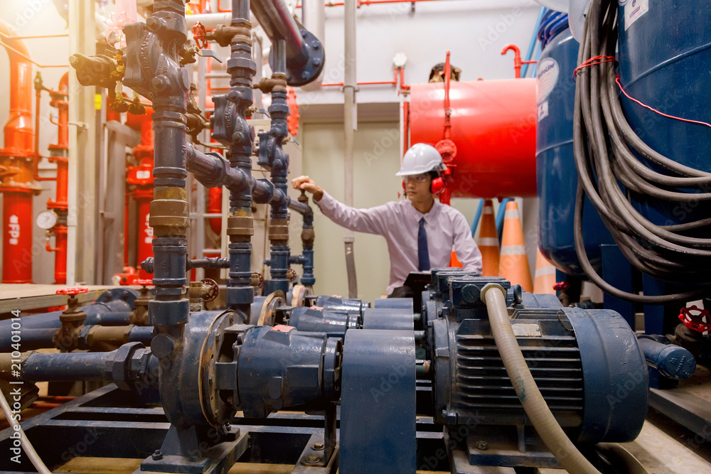 Engineer checking Condenser Water pump and pressure gauge , chiller ...