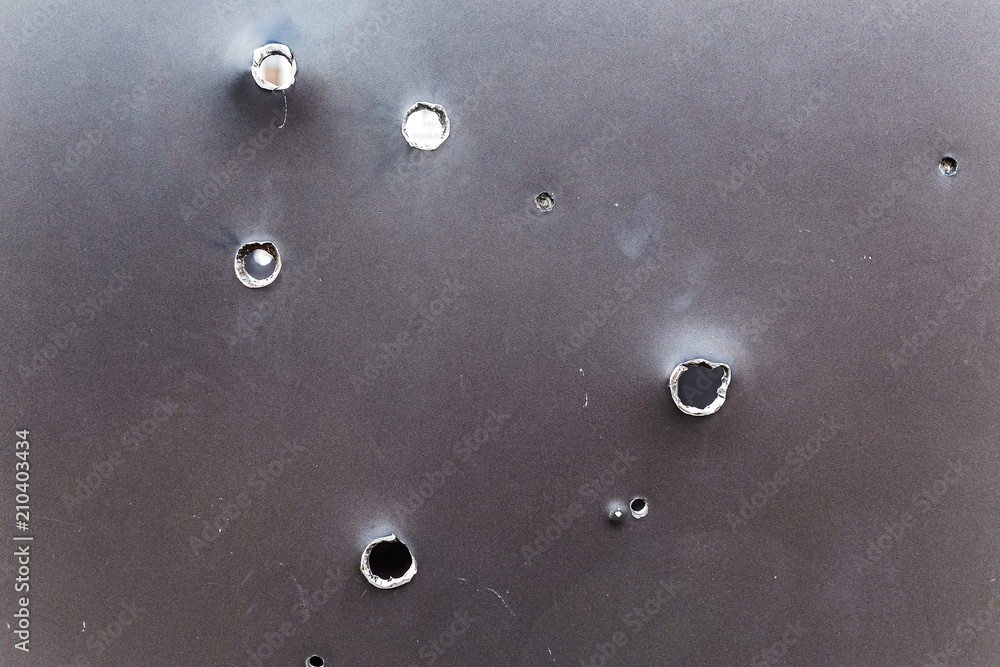 bullet hole in armored metal plate, war conflict and military tragedy ...