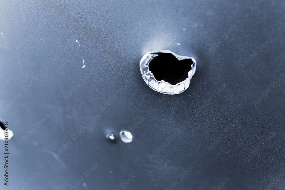 bullet hole in armored metal plate, war conflict and military tragedy ...