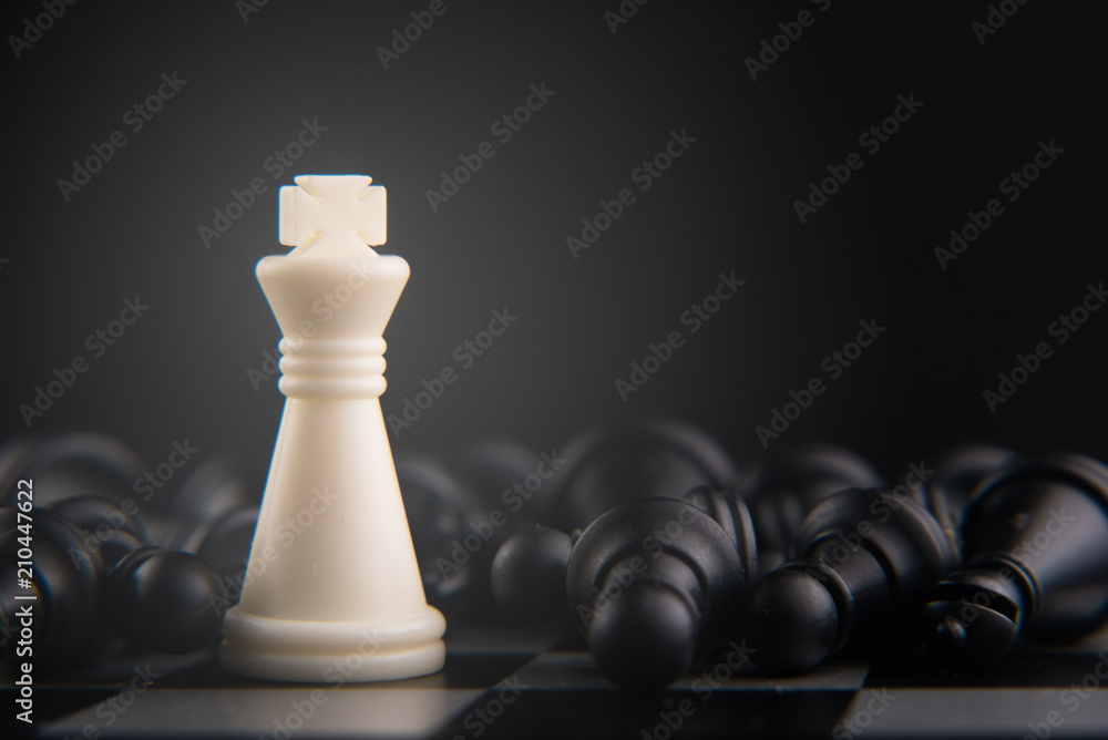 chess set on chess board. white king defeat all. power, hero and ...