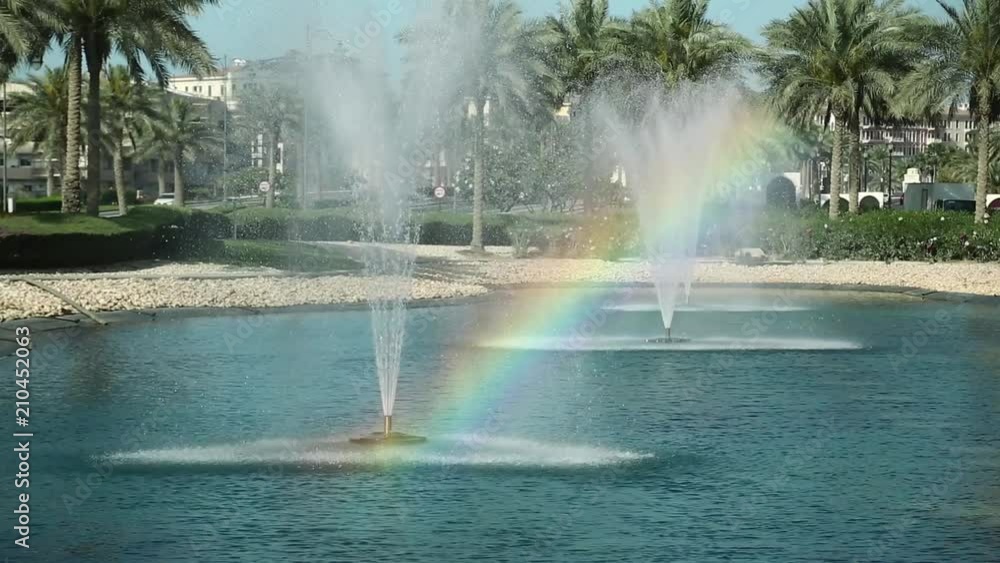 Fountains and colorful rainbow. Rainbow - meteorological phenomenon ...