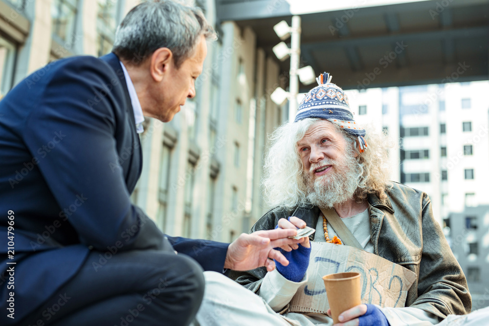Man Giving Money To Homeless