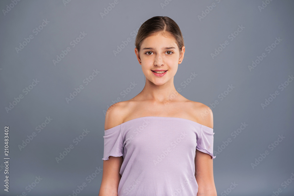 Refined beauty. The portrait of a petite teenage girl in a lilac ...