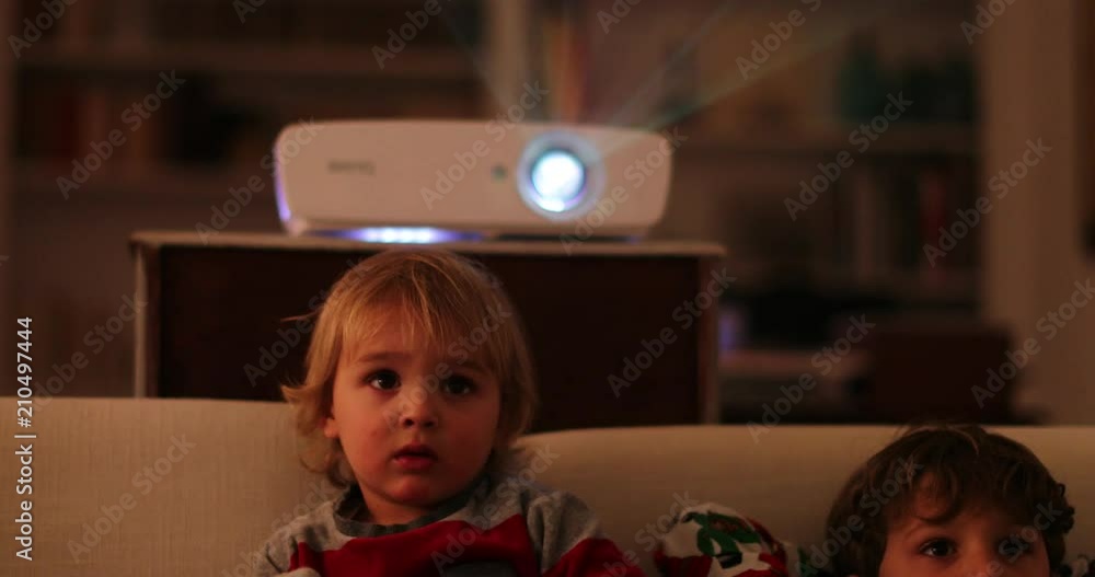 Children watching screen projected. Candid moment of kids sitting on ...