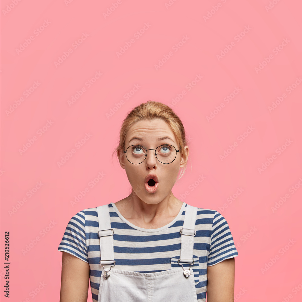 Indoor shot of surprised terrified young European female model looks ...