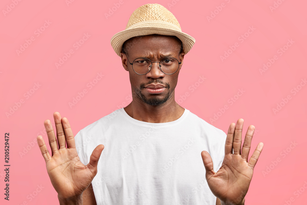 Indoor Shot Of Handsome Displeased African American Male Has Unhappy