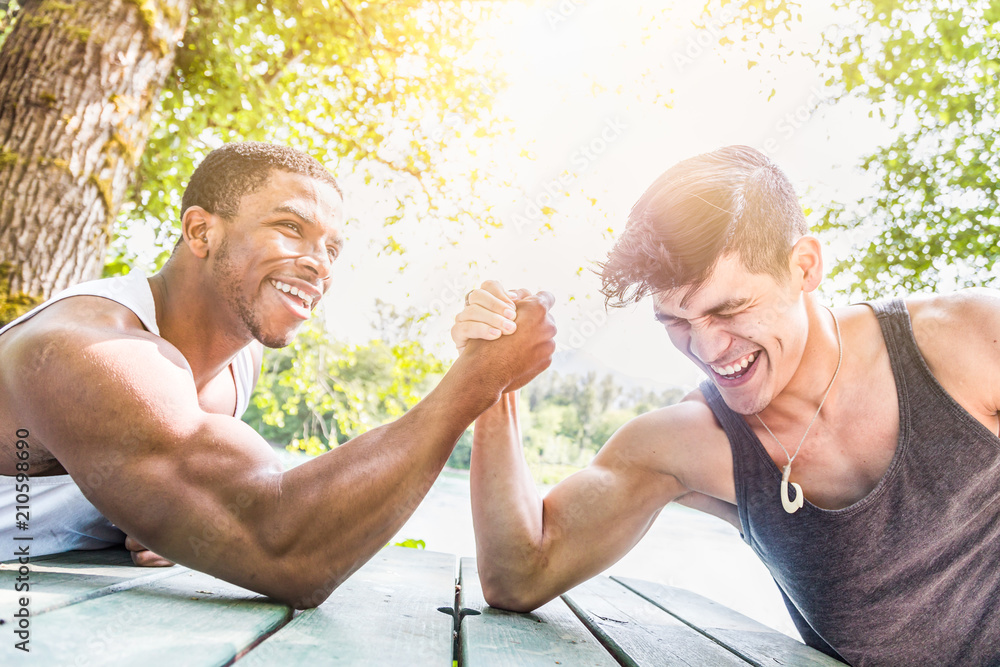 African American Man Arm Wrestling With Mixed Race Man Outdoors Stock ...