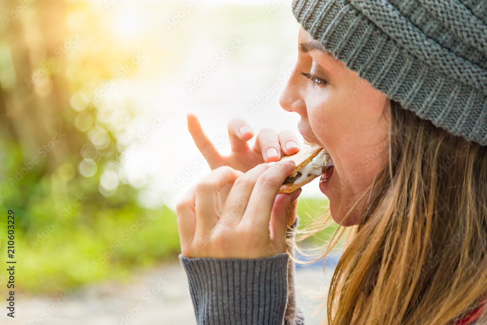 Attractive Young Adult Girl Eating Her Smore with Chocolate and Roasted ...