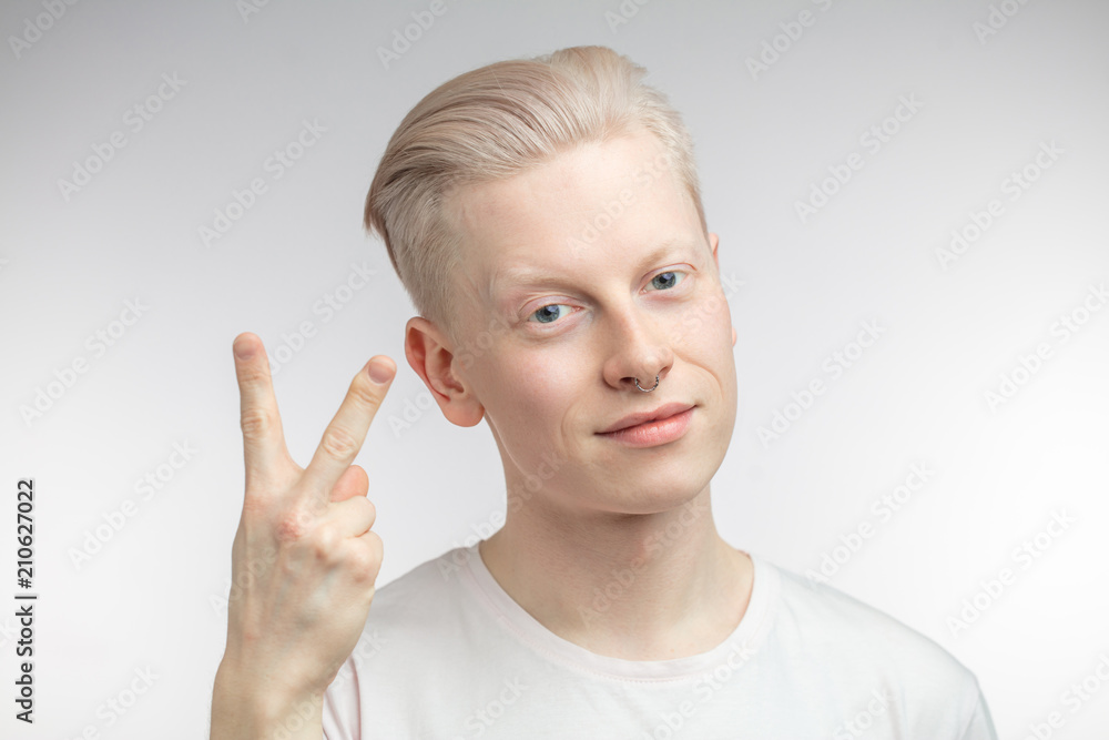 Positive blonde guy shows Victory sign. Win or nothing. Body language ...