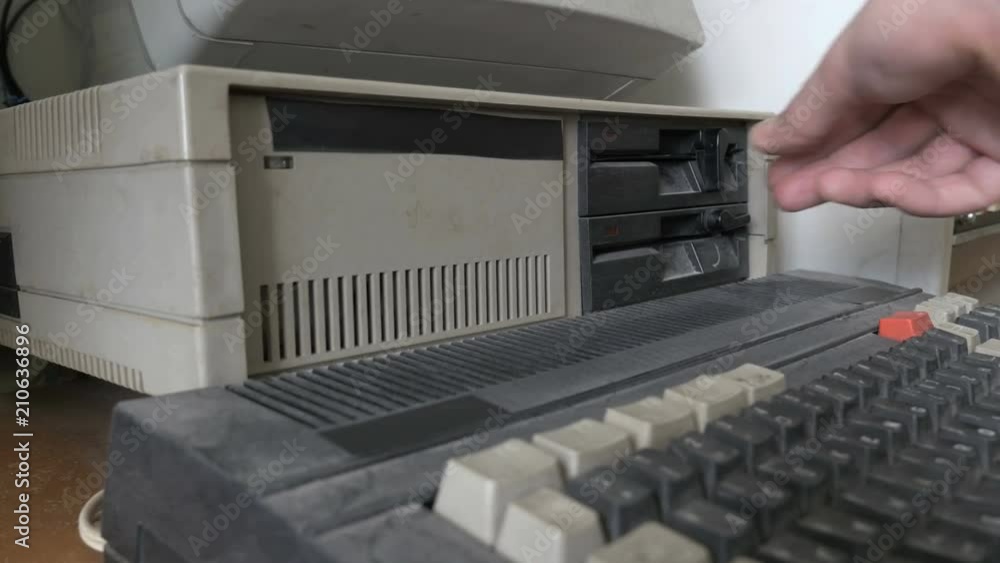 Inserting the 5.25 Inch floppy disk in outdated computer. Old pc 1980s ...