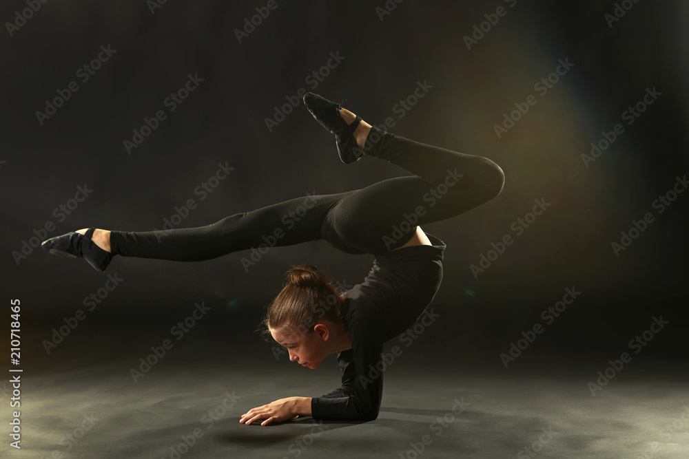 Young girl gymnast on black background Stock Photo | Adobe Stock