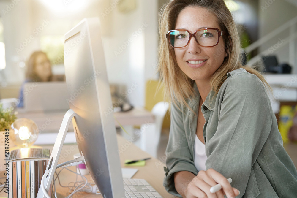 Beautiful woman working on desktop computer, co-working area Stock ...