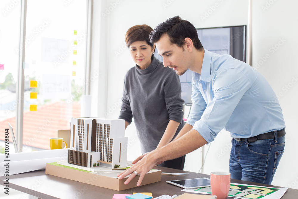 Architect talking to building project together. Attractive architect or ...